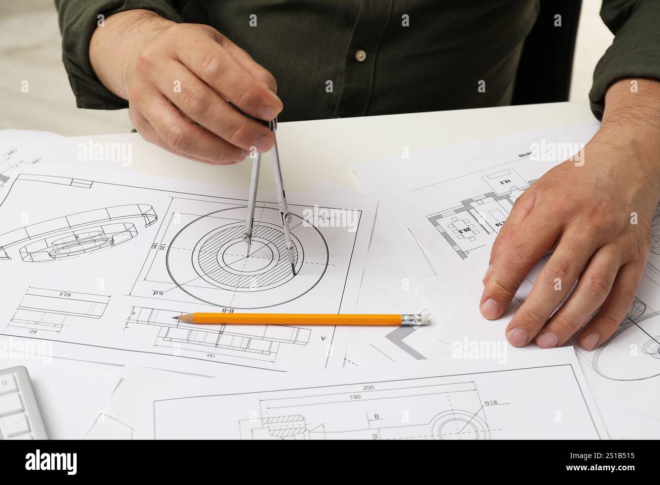Engineer working with project, closeup. Different technical drawings on white table Stock Photo ...