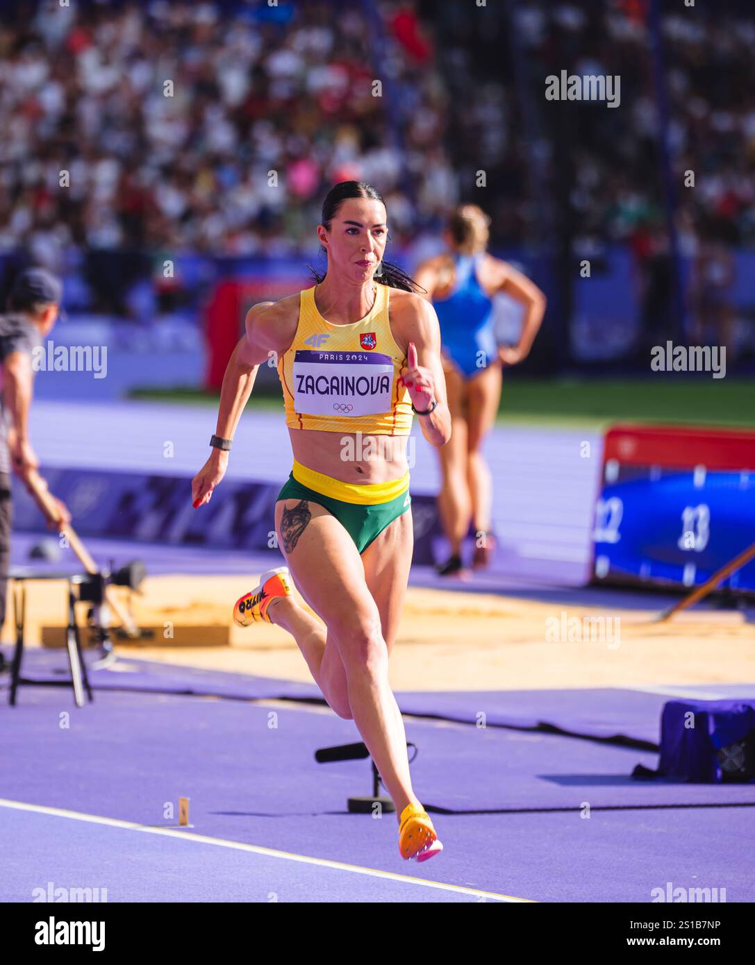 Diana Zagainova celebrating her medal with her country's flag at the ...