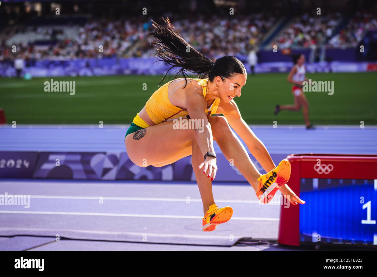 Diana Zagainova celebrating her medal with her country's flag at the ...