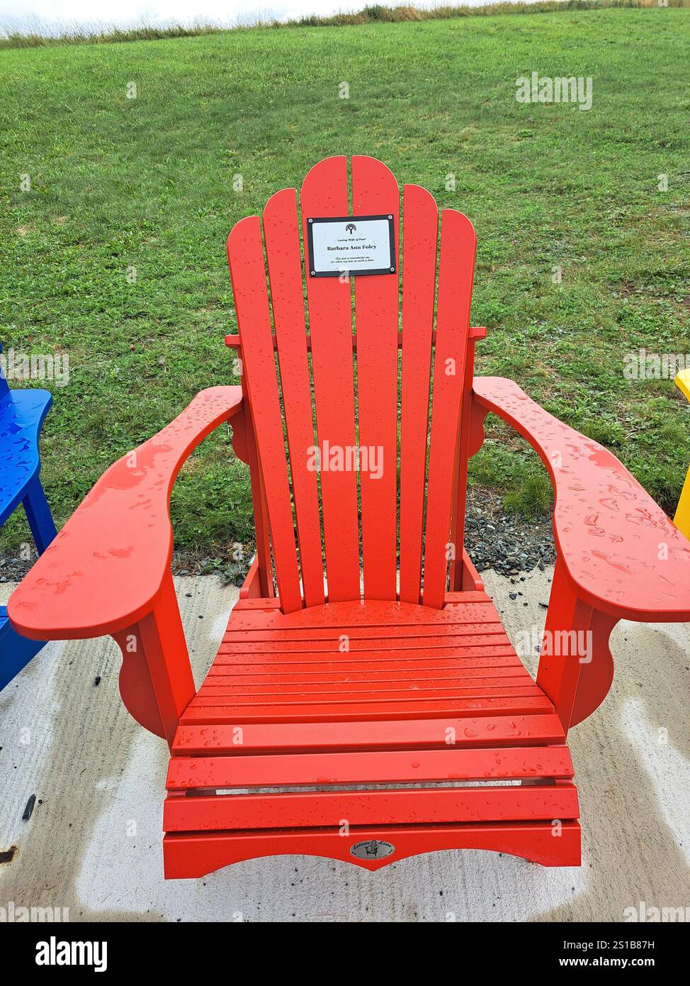 Red Adirondack chair at the Bell Island light station in Newfoundland ...