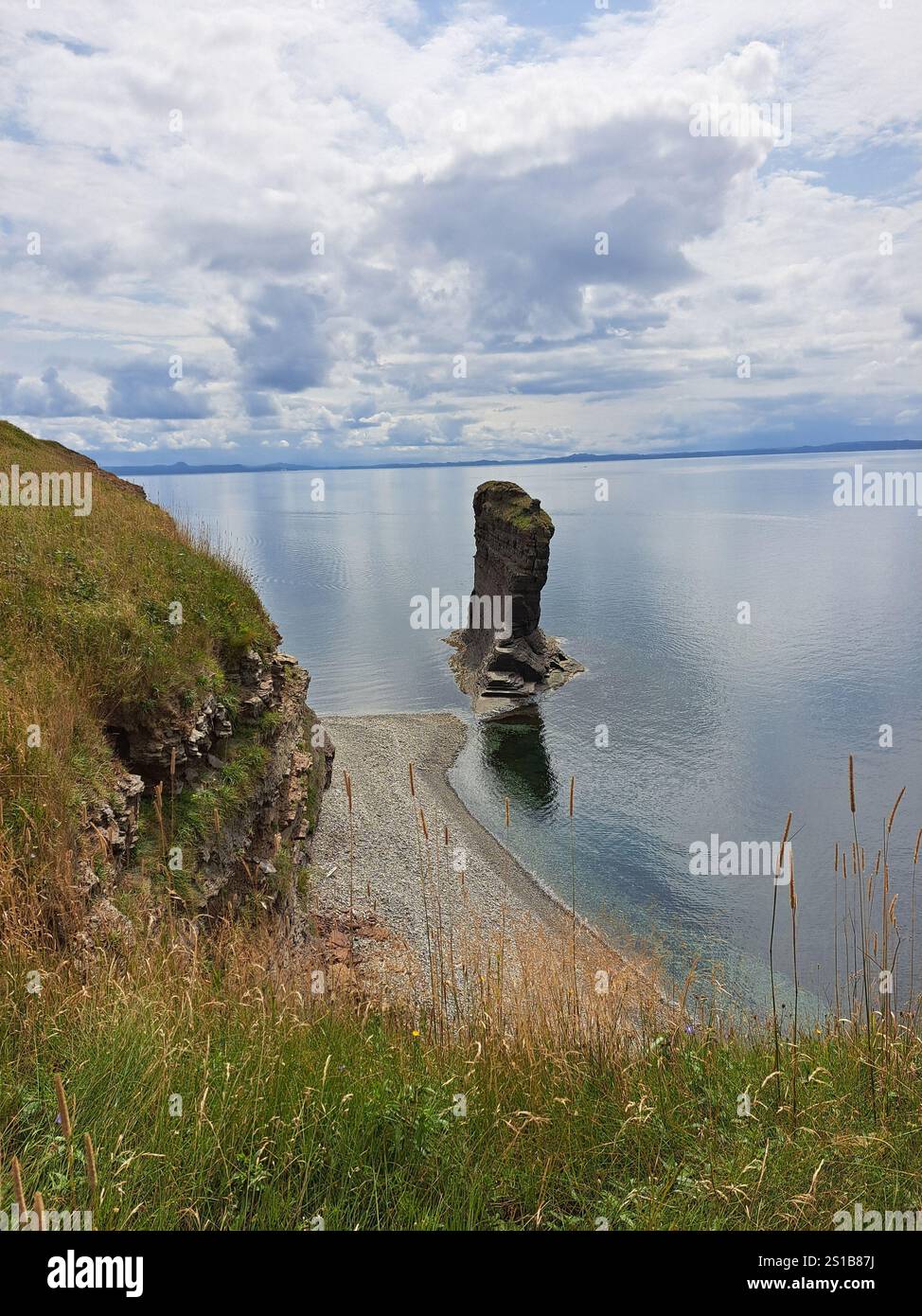 Skinny sea stack on the beach near the Bell on Bell Island ...