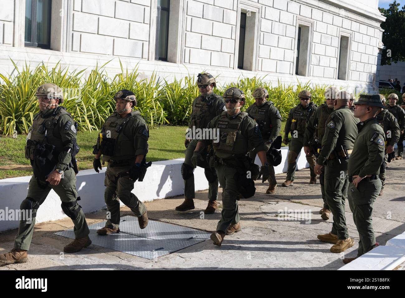 Police with the Special Arrests Unit arrive as protesters crowd the ...