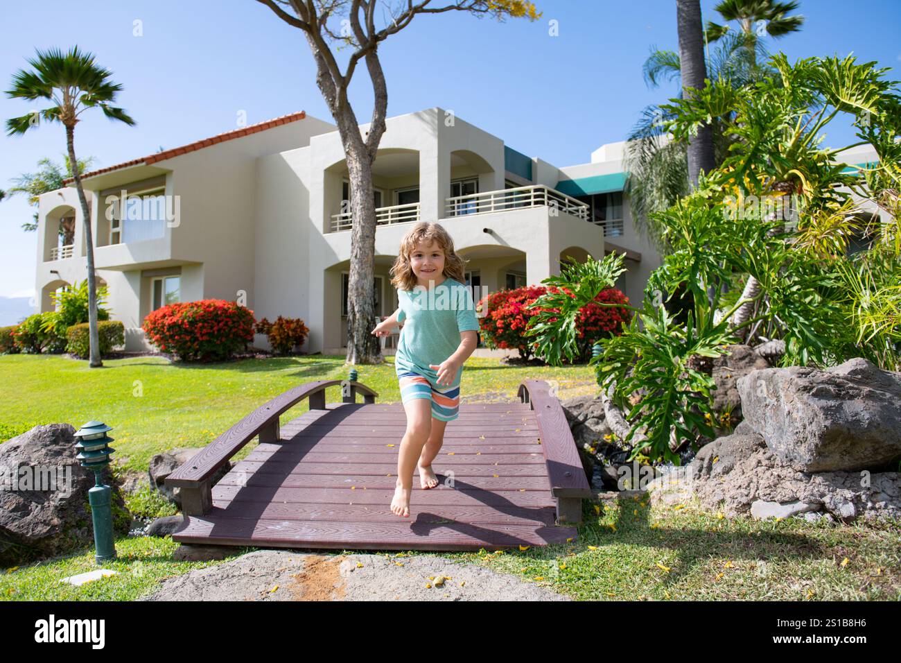 Happy kid boy running on backyard. Active healthy child boy runner run ...