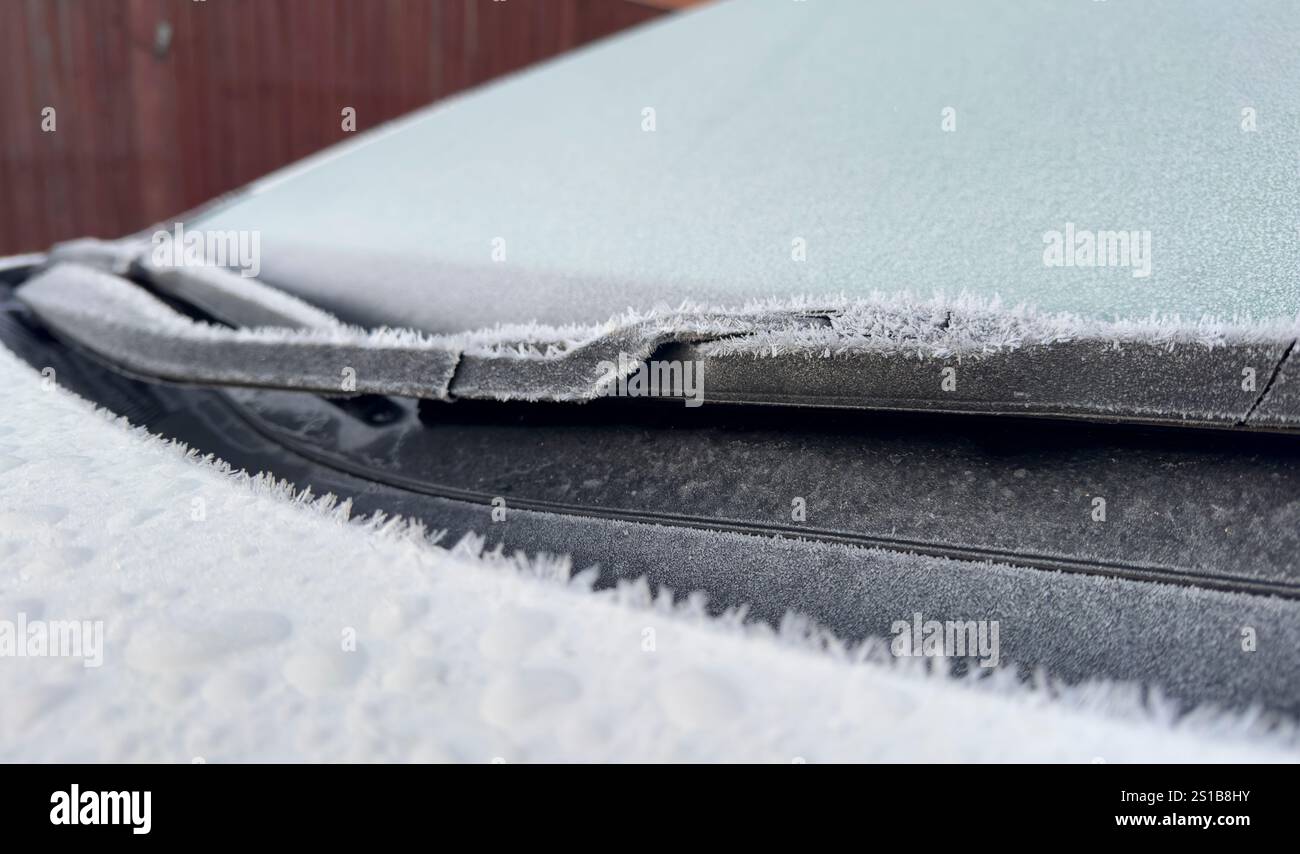 frozen windshield wiper. concept of dangerous driving during the winter ...