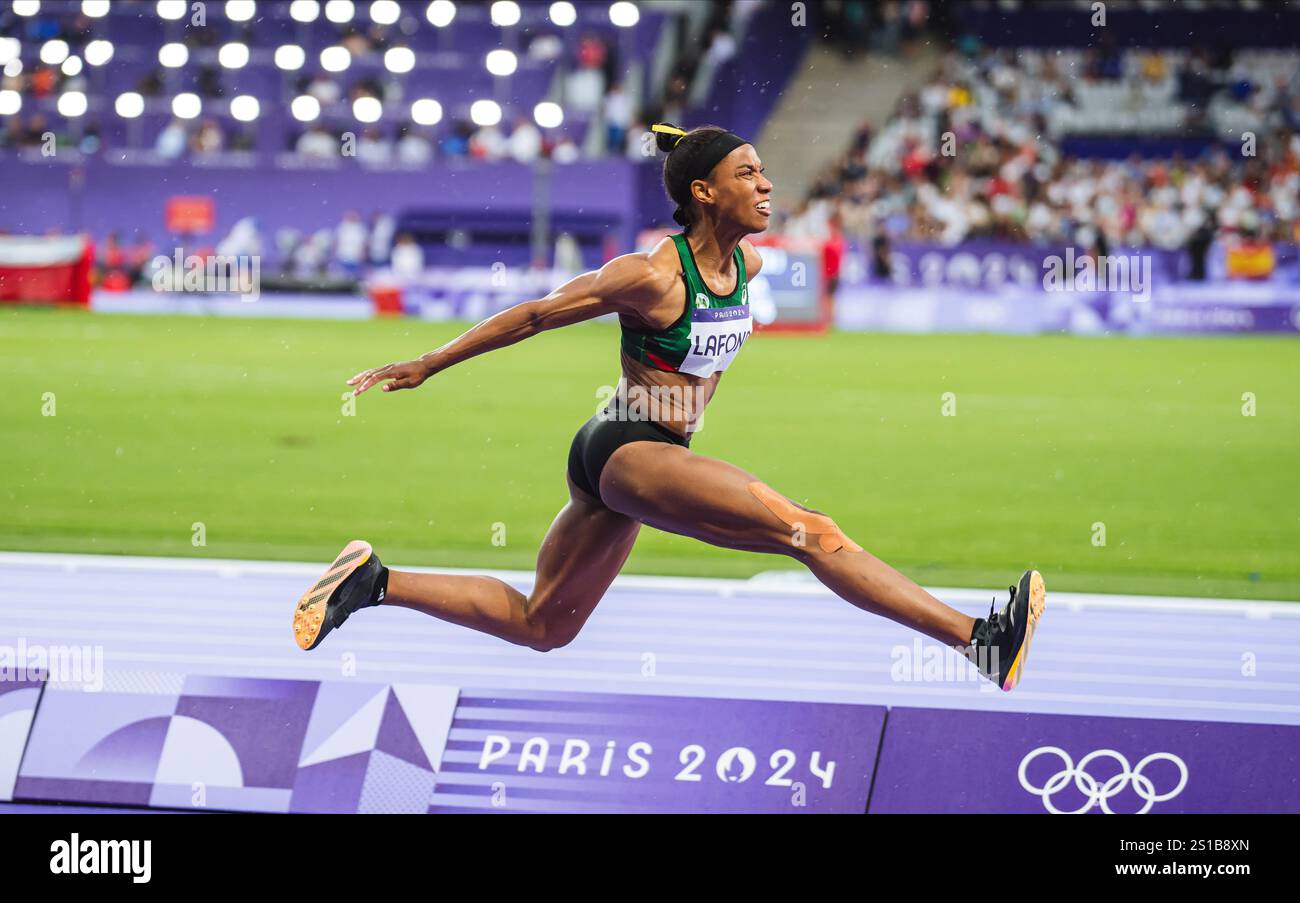 Thea LaFond participating in the triple jump at the Paris 2024 Olympic ...