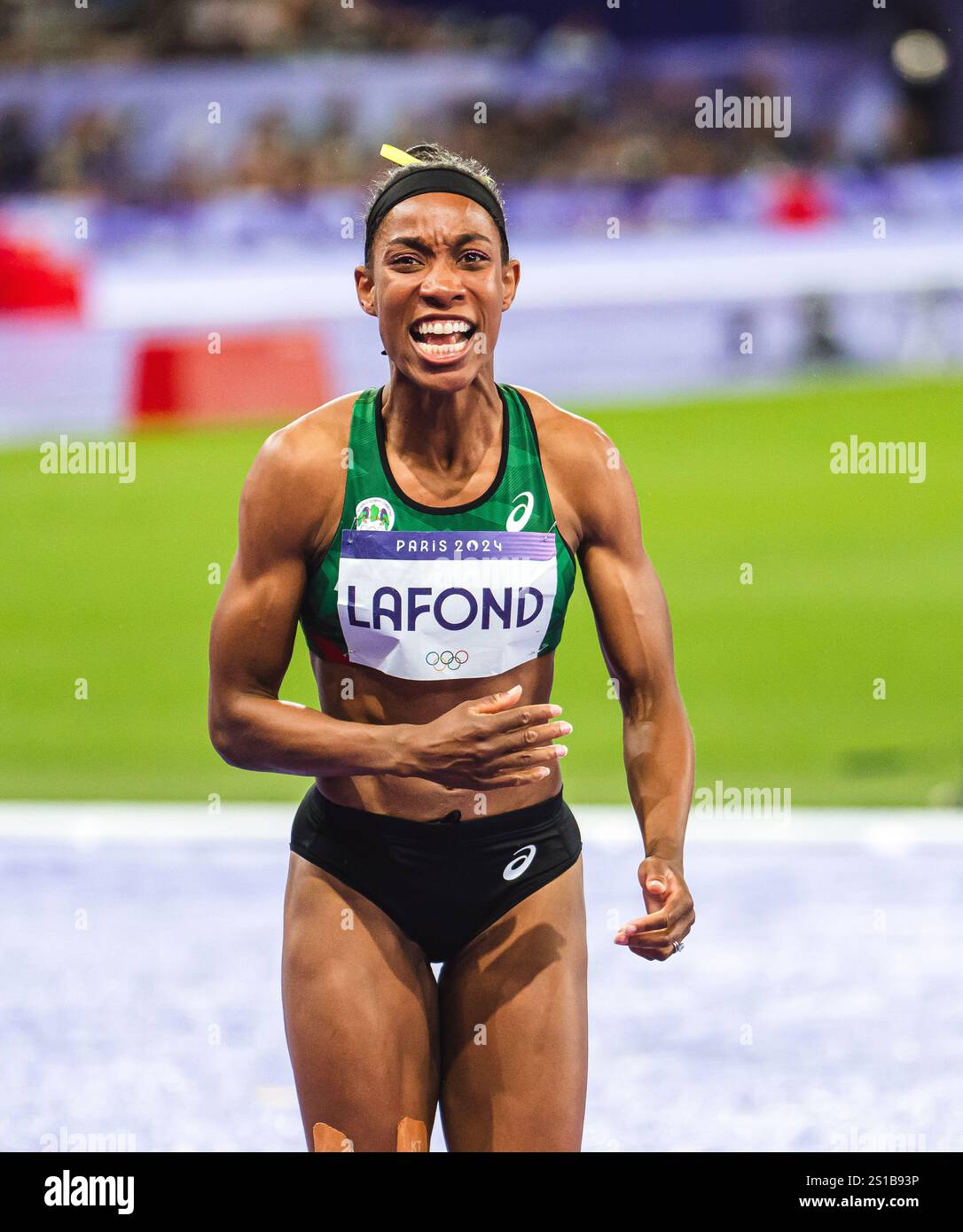 Thea LaFond celebrating her medal with her country's flag at the Paris ...