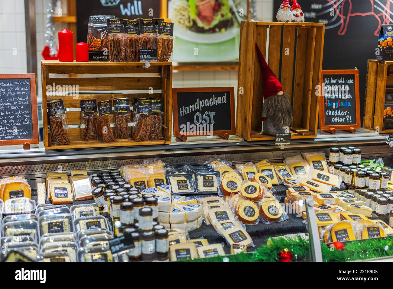 Cheese and snack display in grocery store with wooden shelves, packaged ...