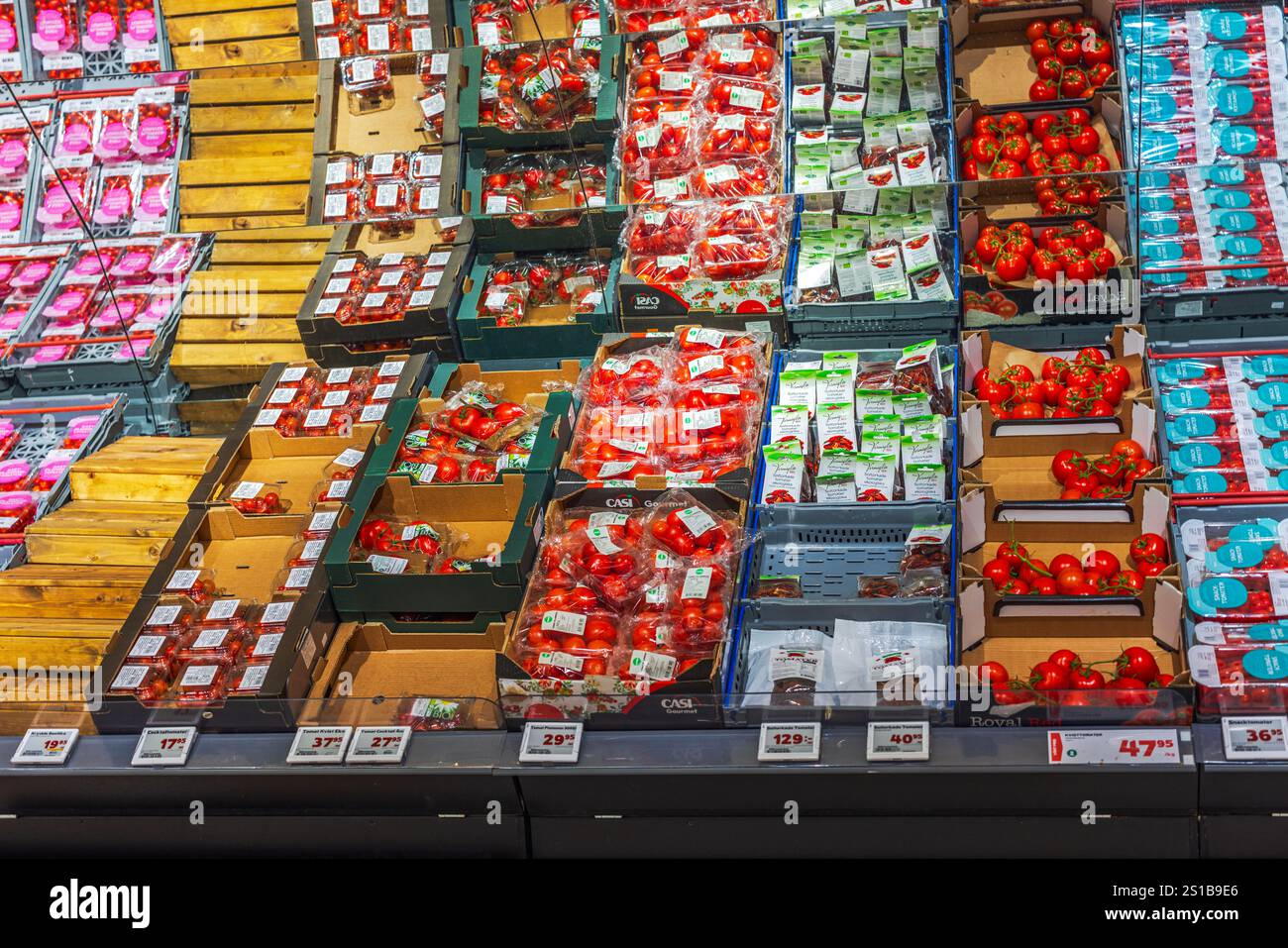 Fresh display of red tomatoes in grocery store vegetable section with ...