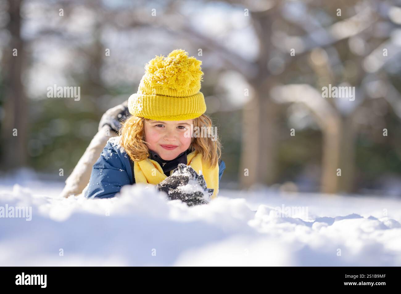 Child playing with snow, outdoors during snowfall. Winter child ...
