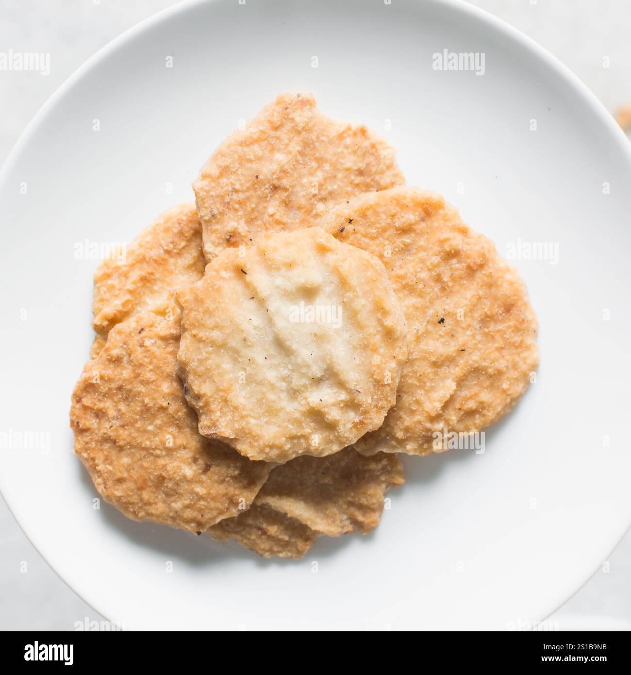 Top view of fried corn stick snack on a white granite countertop ...