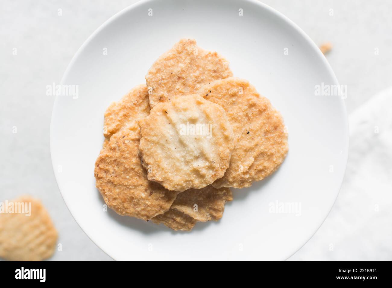Top view of fried corn stick snack on a white granite countertop ...