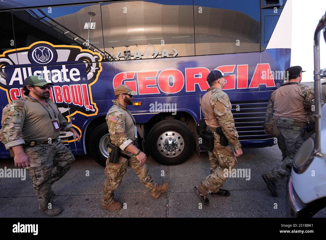 FBI SWAT team members walk past the Georgia bus as the team arrives at ...