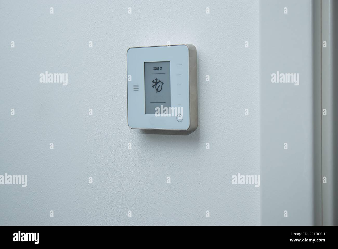 A modern electric thermostat control system on white wall Stock Photo ...