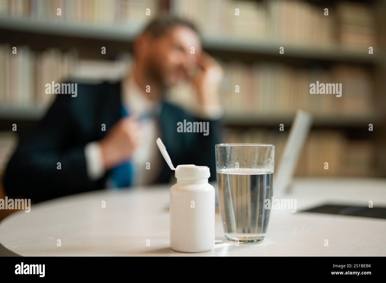 Business man suffering from headache after computer work, exhausted ...