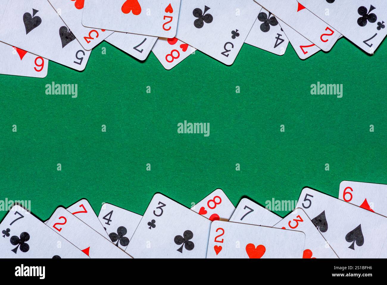 Playing cards on green felt casino table. Background with copy space ...