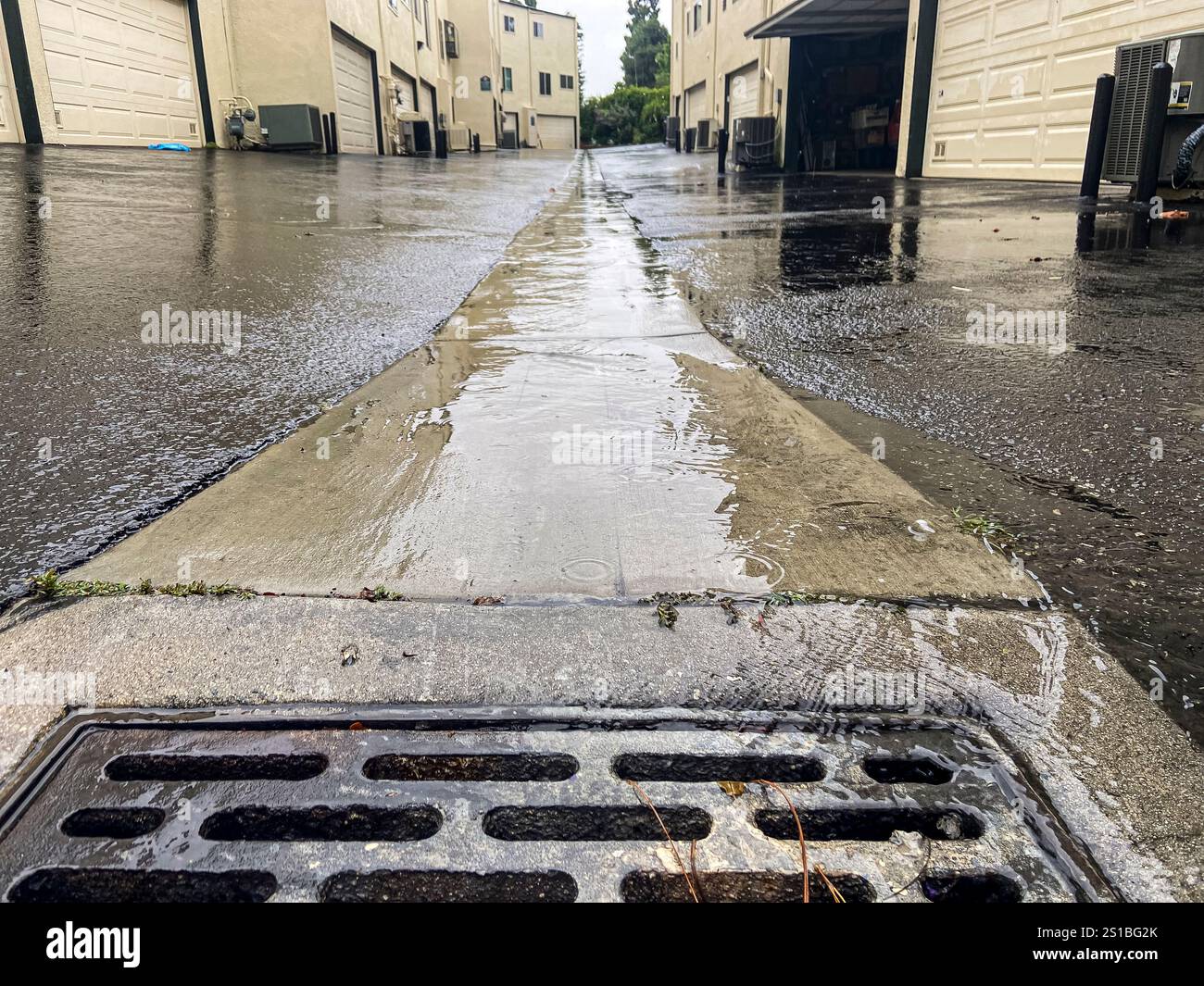 Storm drain in alley in apartment complex during Tropical Storm Hilary ...