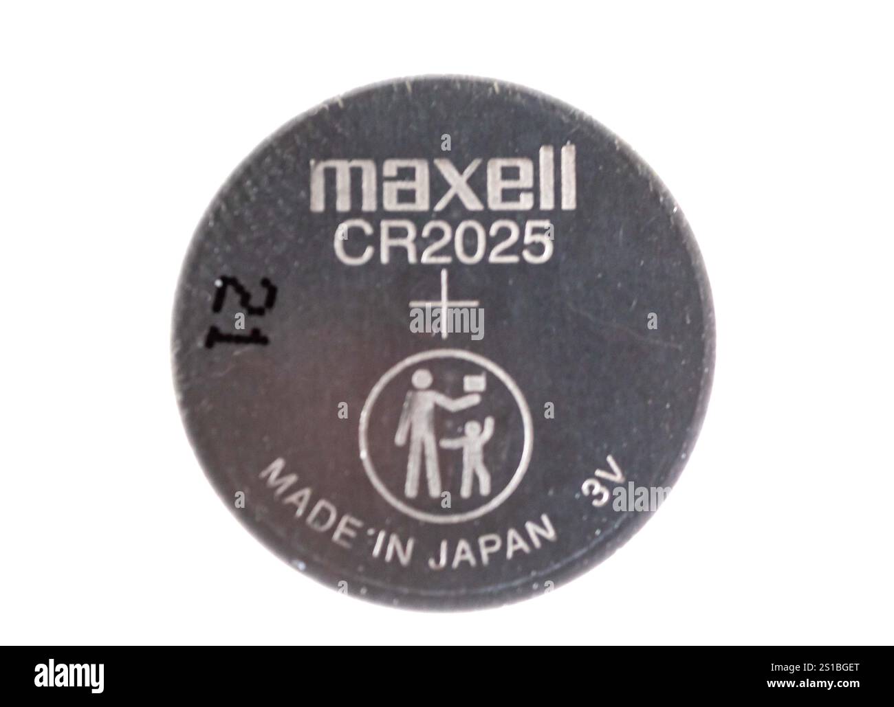 CR2025 button cell lithium battery 3V maxell isolated Stock Photo - Alamy