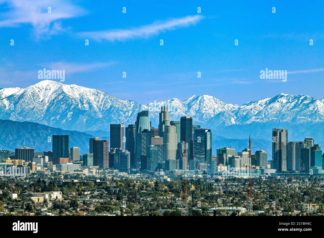 Los Angeles Skyline with snow covered San Gabriel Mountains in ...