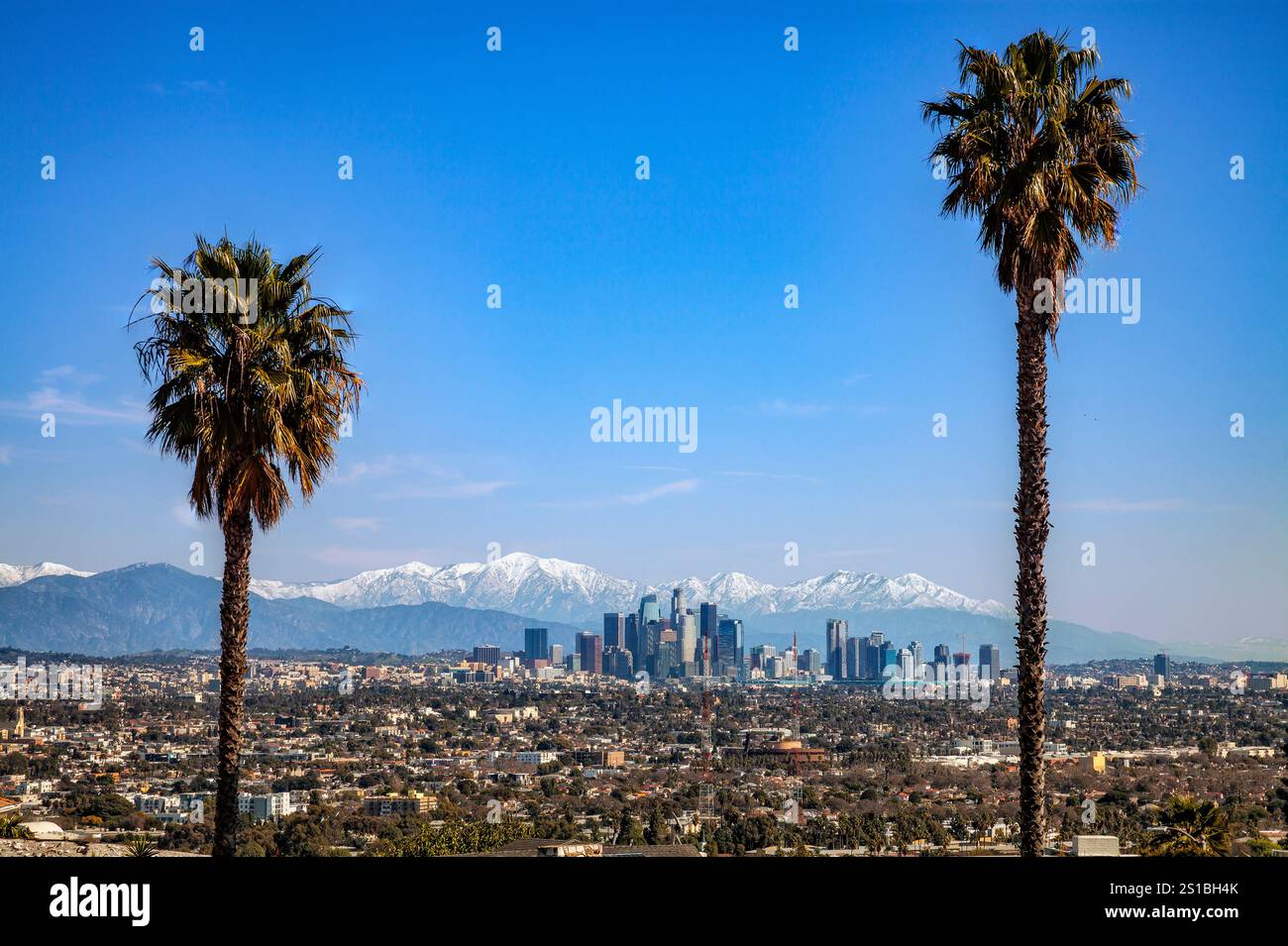 Los Angeles Skyline with snow covered San Gabriel Mountains in ...