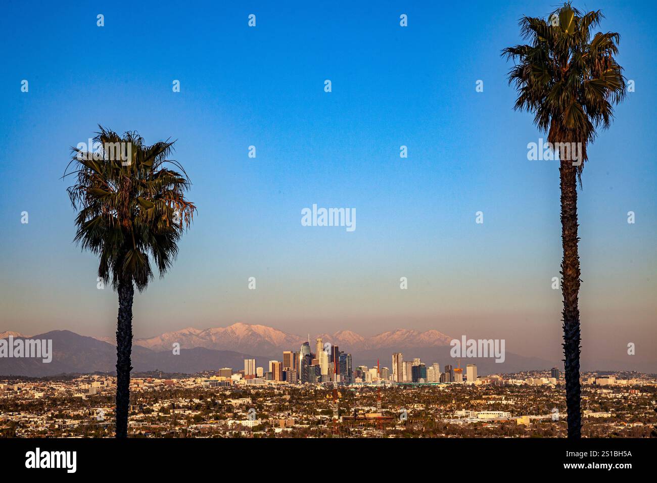 Los Angeles Skyline with snow covered San Gabriel Mountains in ...