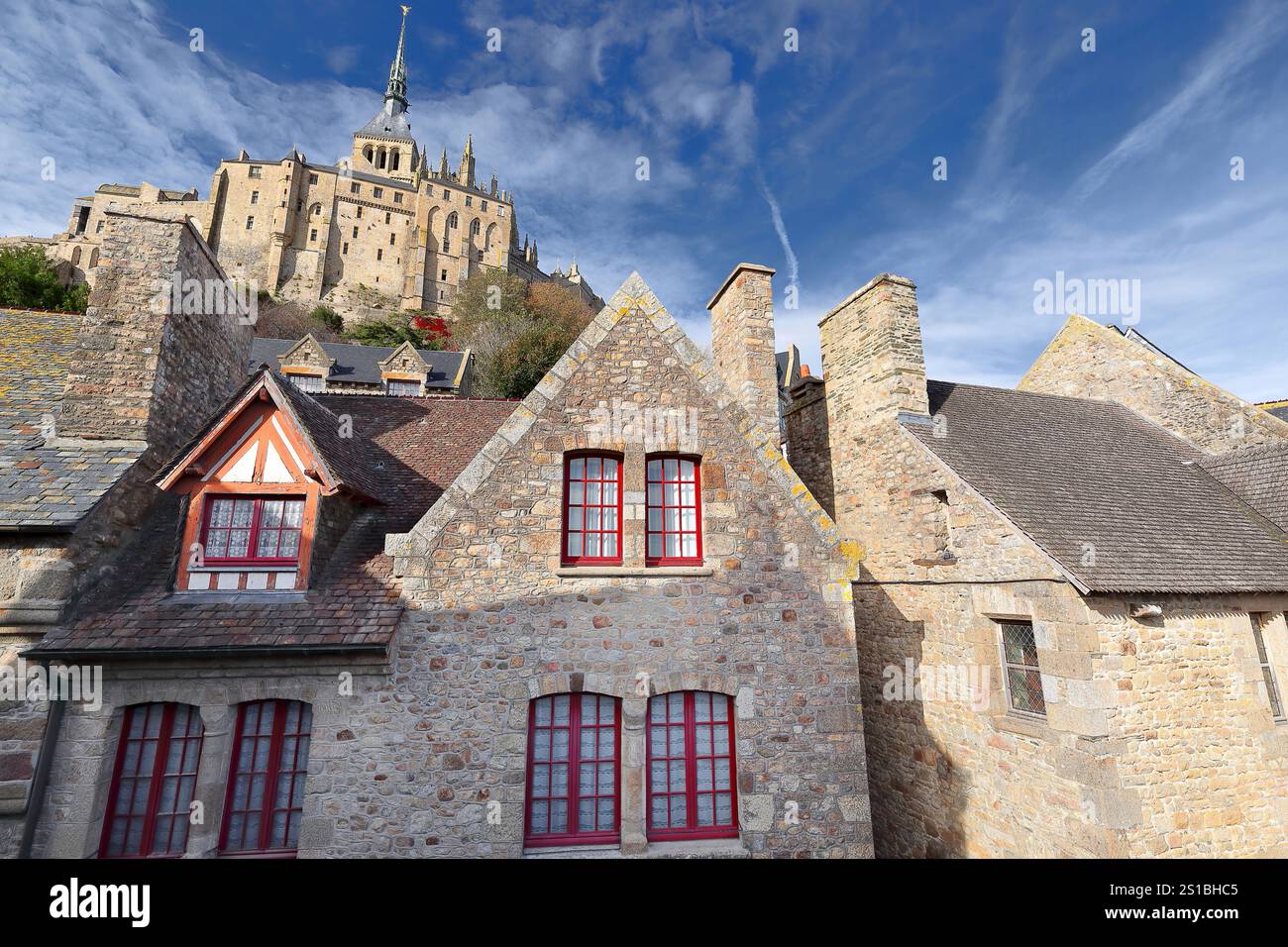 148 Mont-Saint-Michel. Chimneys and dormers crown pointed roofs of ...