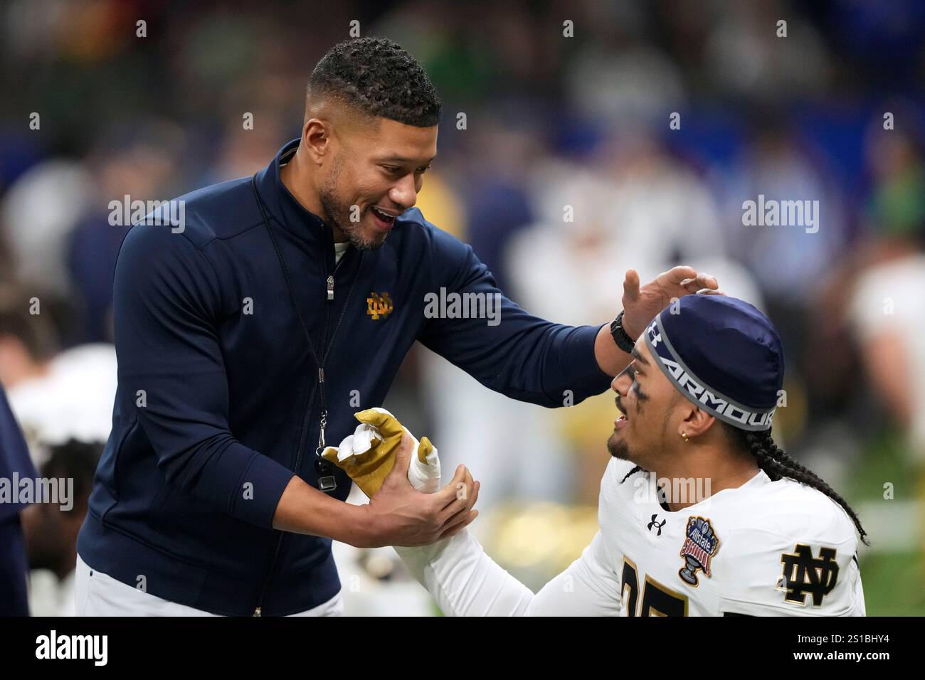 Notre Dame head coach Marcus Freeman talks with one of his players ...