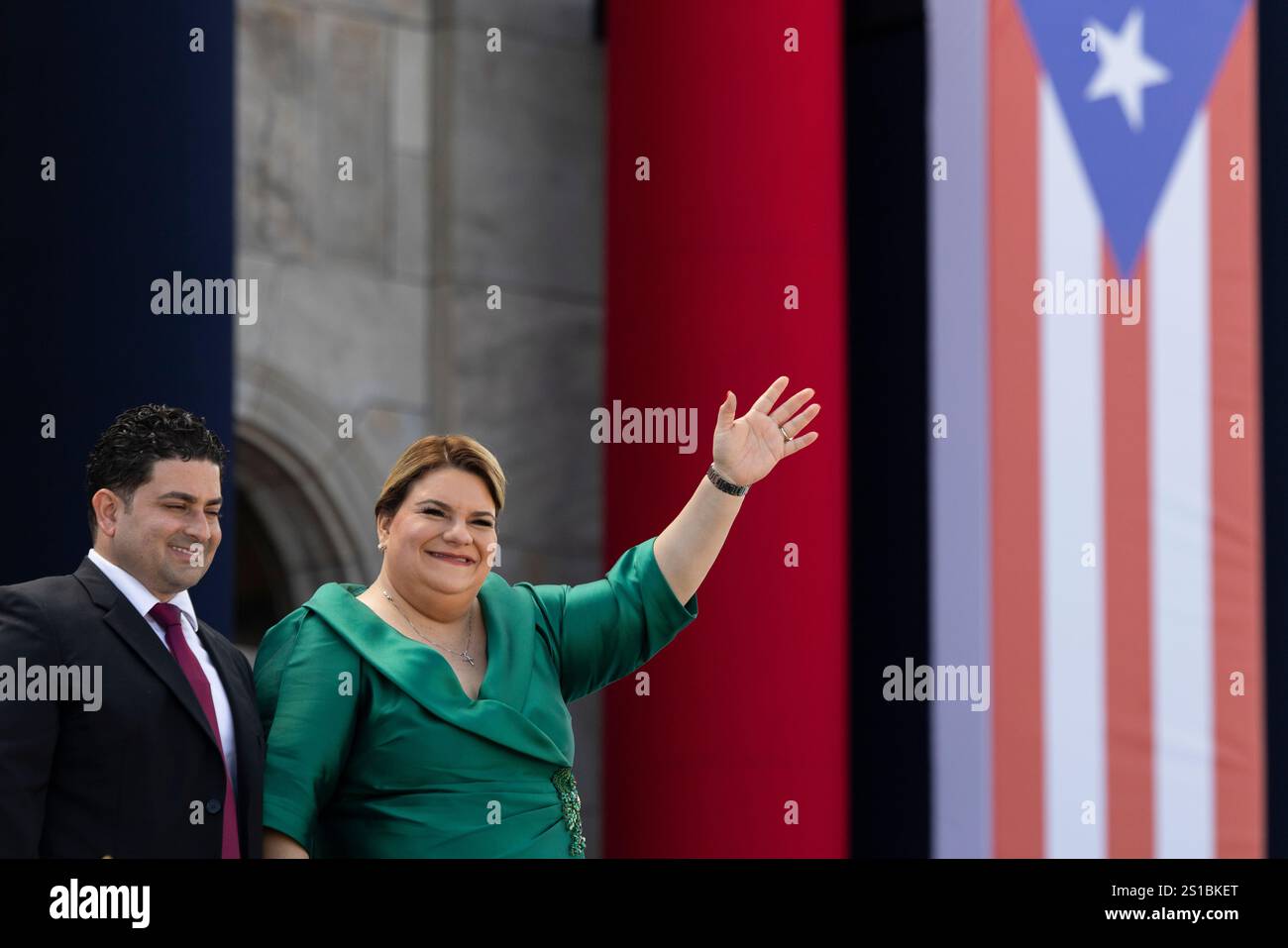 Jenniffer Gonzalez Colon waves alongside her husband Jose Yovin Vargas ...