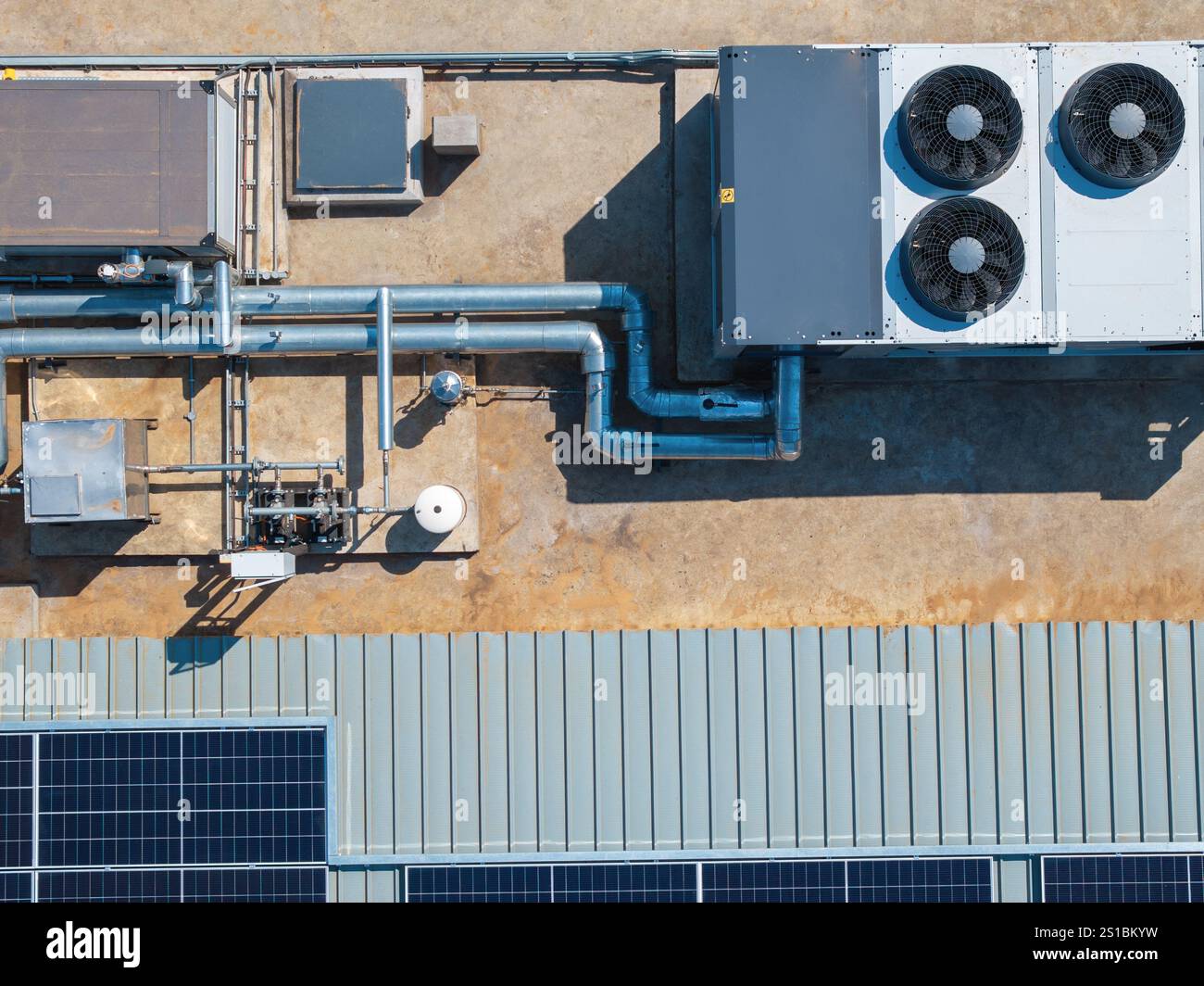 air conditioning industrial in top of a building roof, ac unit and pipe ...