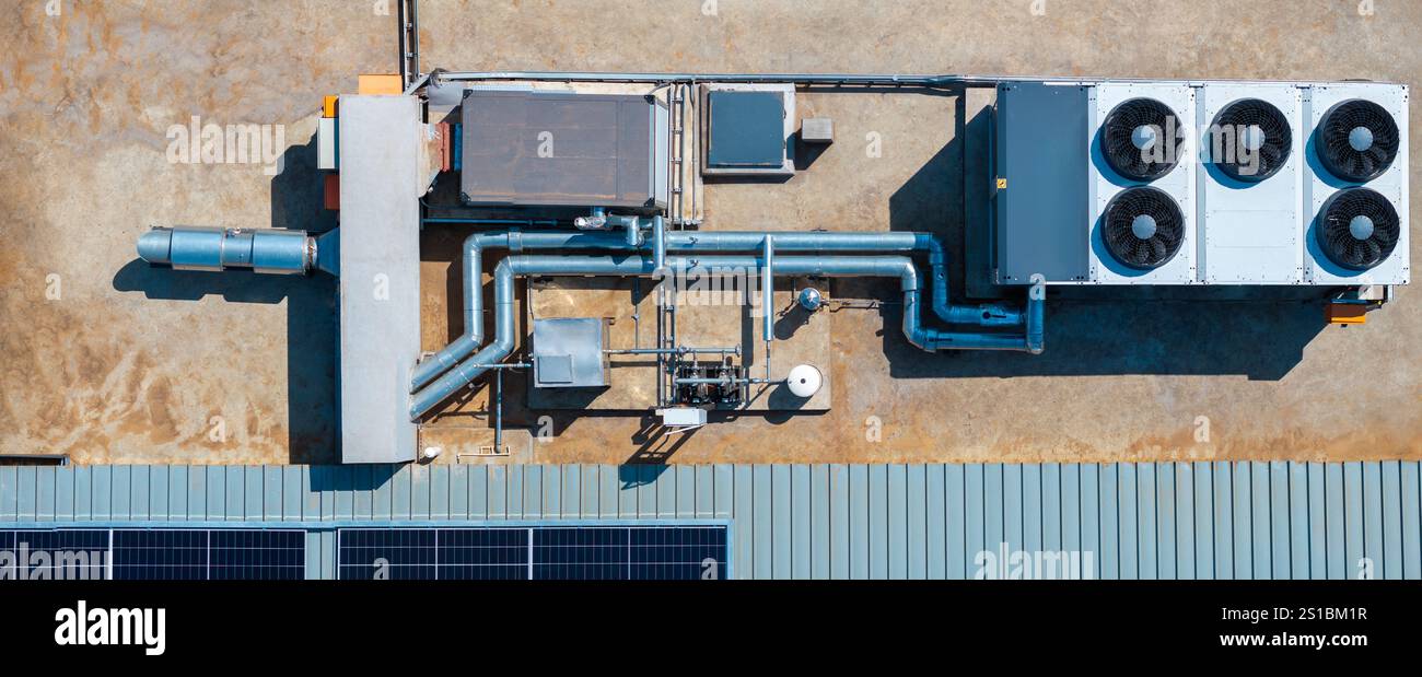 air conditioning industrial in top of a building roof, ac unit and pipe ...