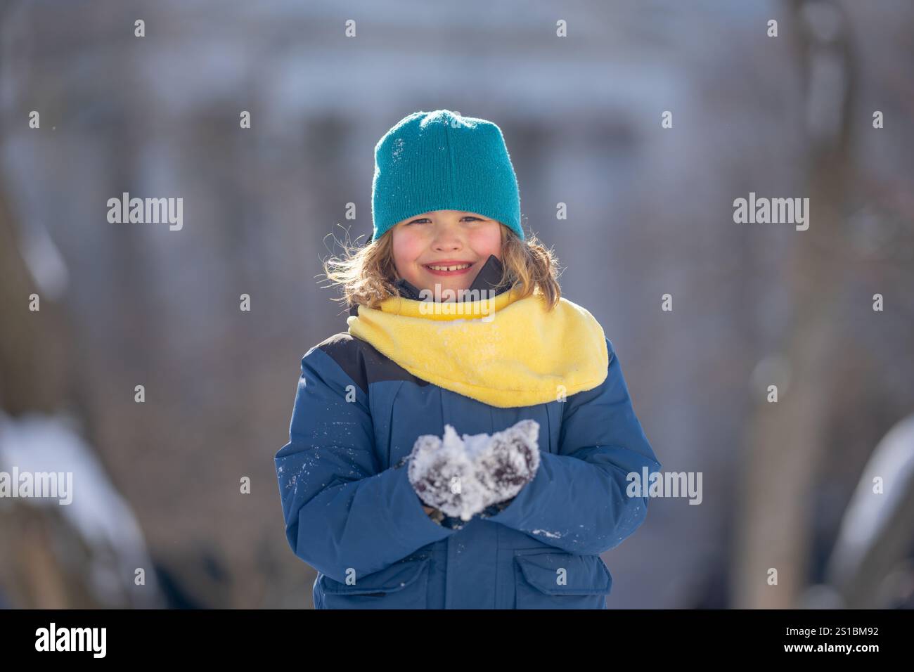 Child playing with snow, outdoors during snowfall. Winter child ...