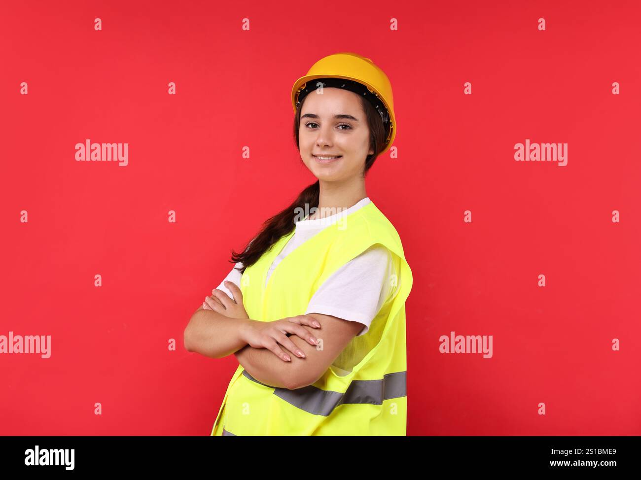 Girl with safety equipment on red background. Work for teenagers Stock ...