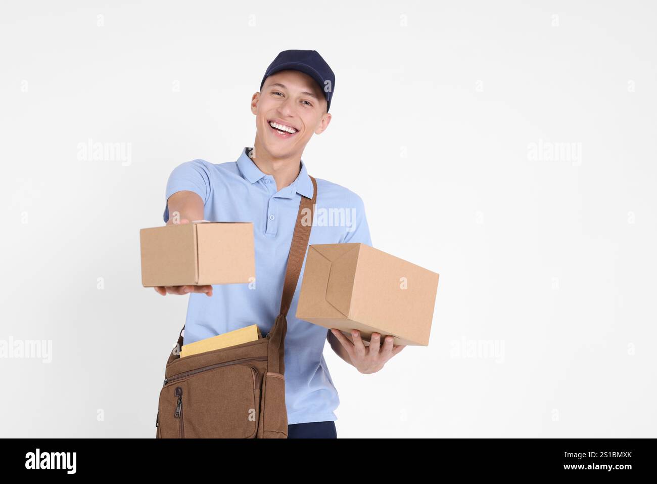 Happy postman with bag and parcels on white background Stock Photo - Alamy