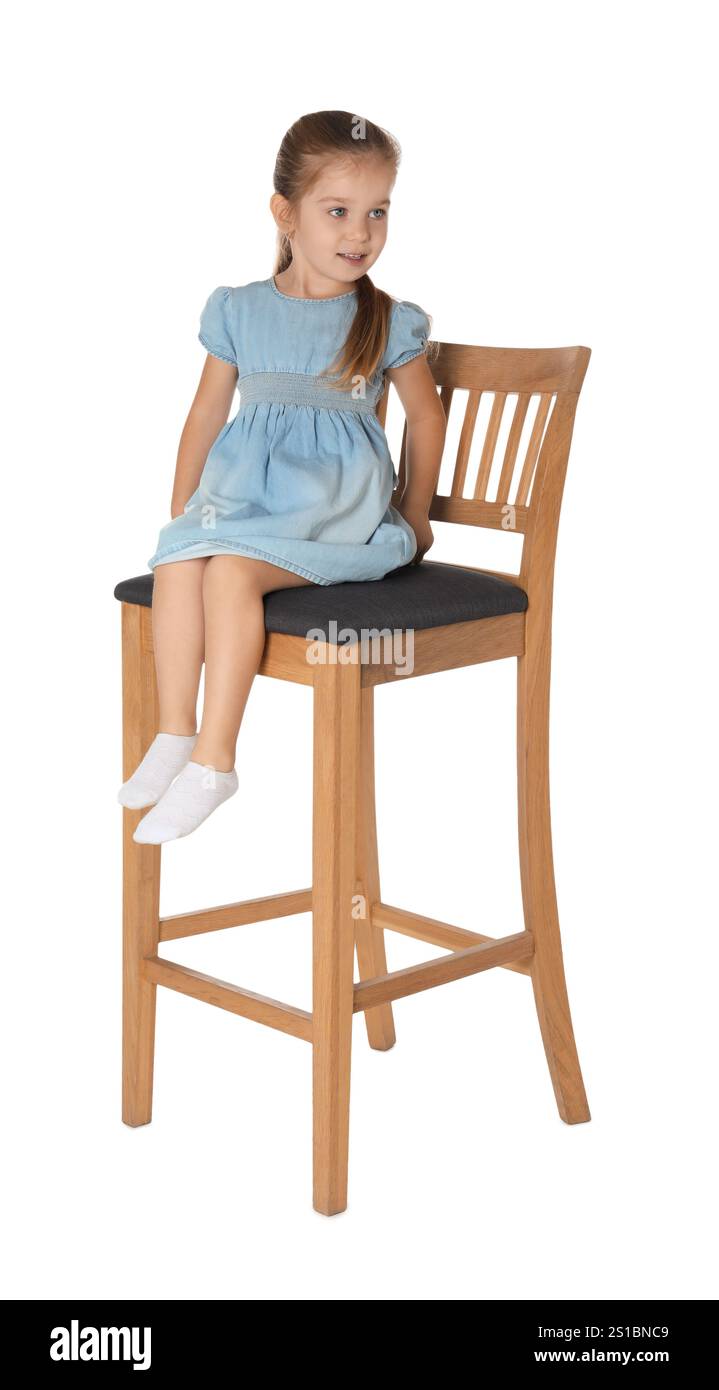 Little girl sitting on stool against white background Stock Photo - Alamy