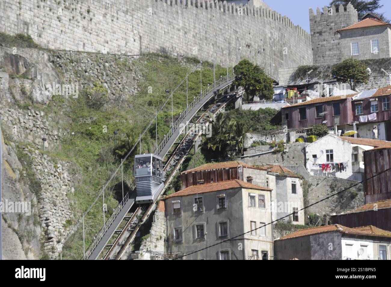 Old town Porto, City funicular railway runs along buildings on a steep ...