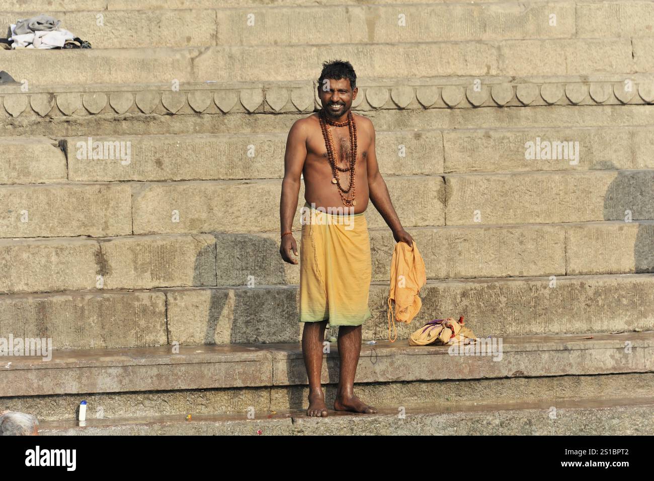 Varanasi, Uttar Pradesh, India, Asia, A man in traditional dress stands ...