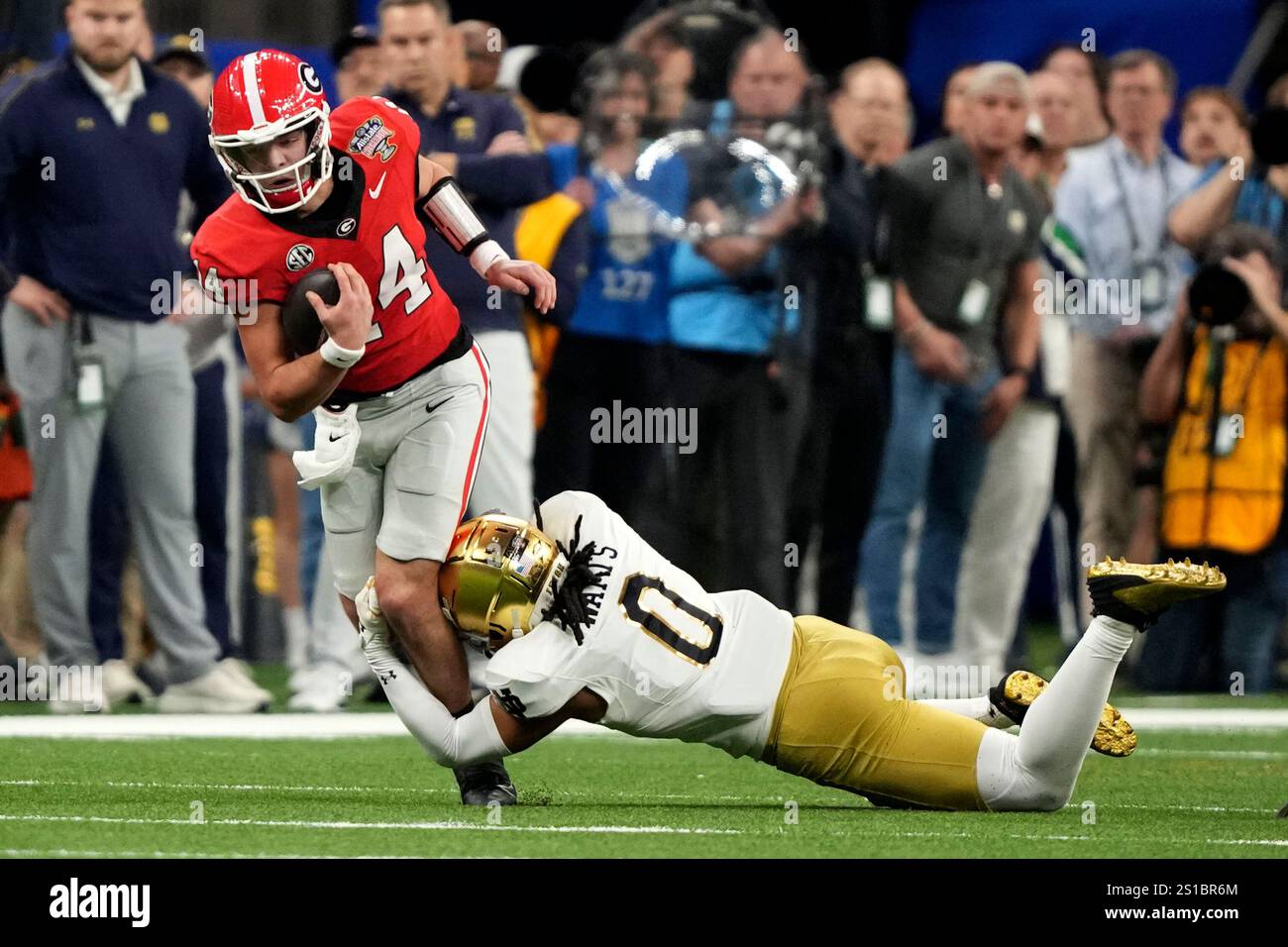 Georgia quarterback Gunner Stockton (14) is tackled by Notre Dame ...