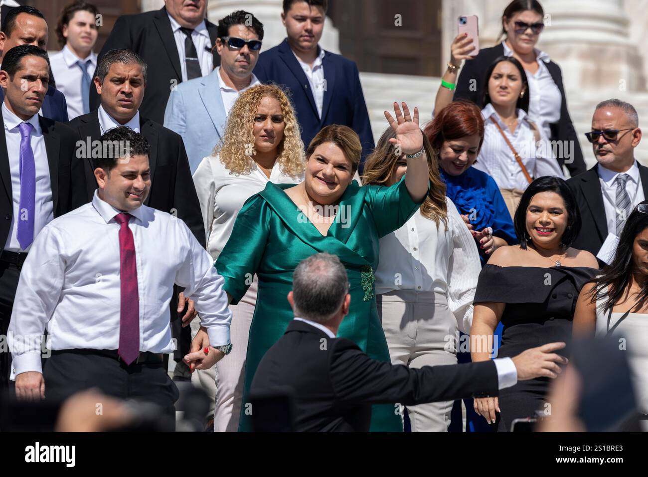 Jenniffer Gonzalez Colon waves next to her husband Jose Yovin Vargas ...