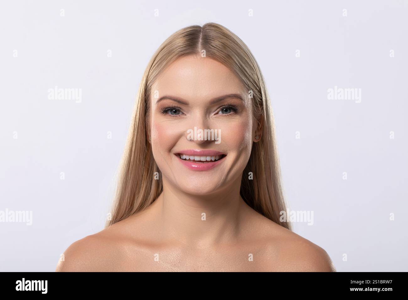 A smiling woman with long flowing hair illuminated by natural soft ...