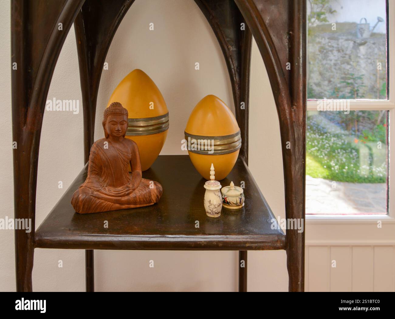 Wooden buddha statue on a shelf Stock Photo - Alamy