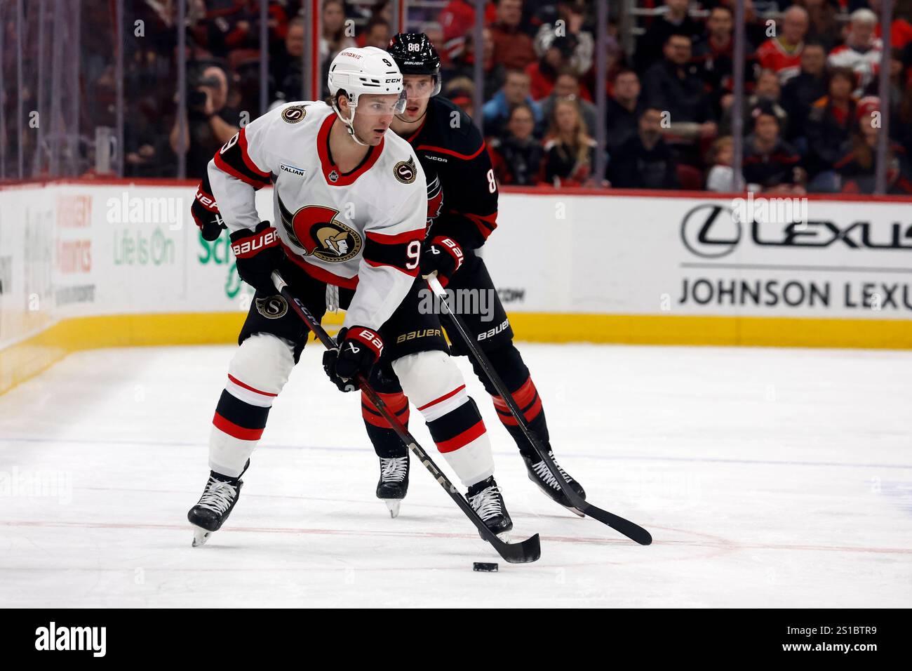 Ottawa Senators' Josh Norris (9) controls the puck in front of Carolina ...
