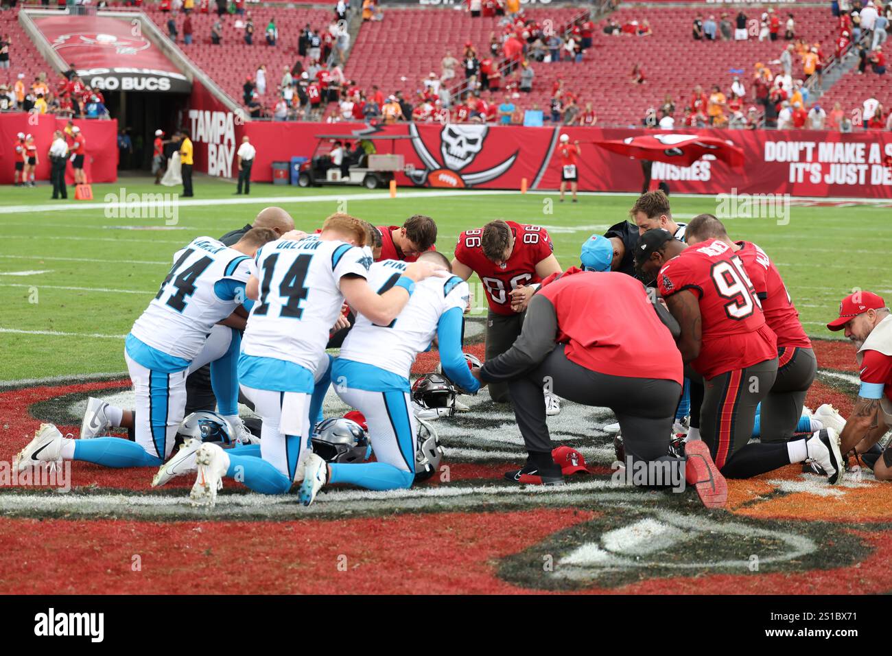 Players from both teams pray following an NFL football game against the ...