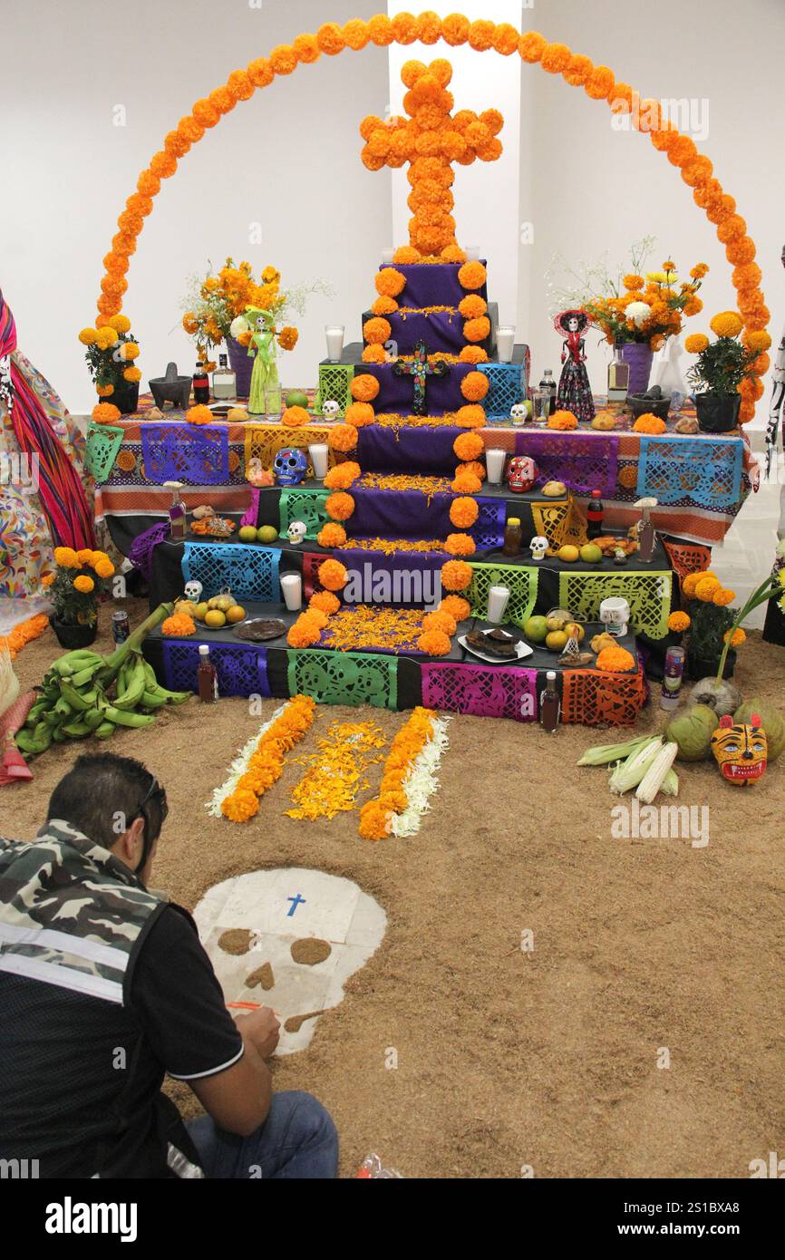 Man puts handmade Day of the Dead offering with skulls, cempasuchil ...