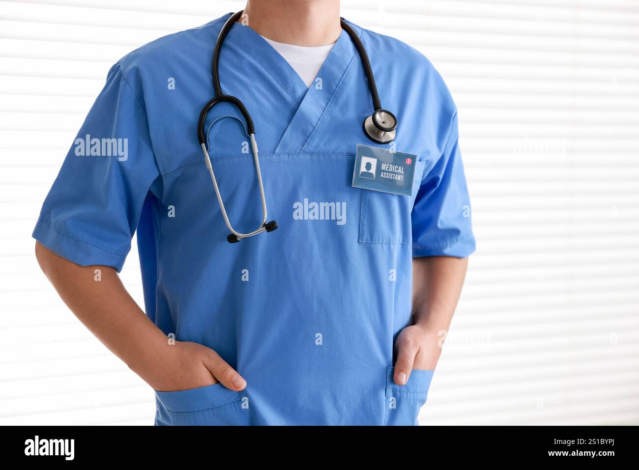 Medical assistant with badge on white background, closeup Stock Photo ...