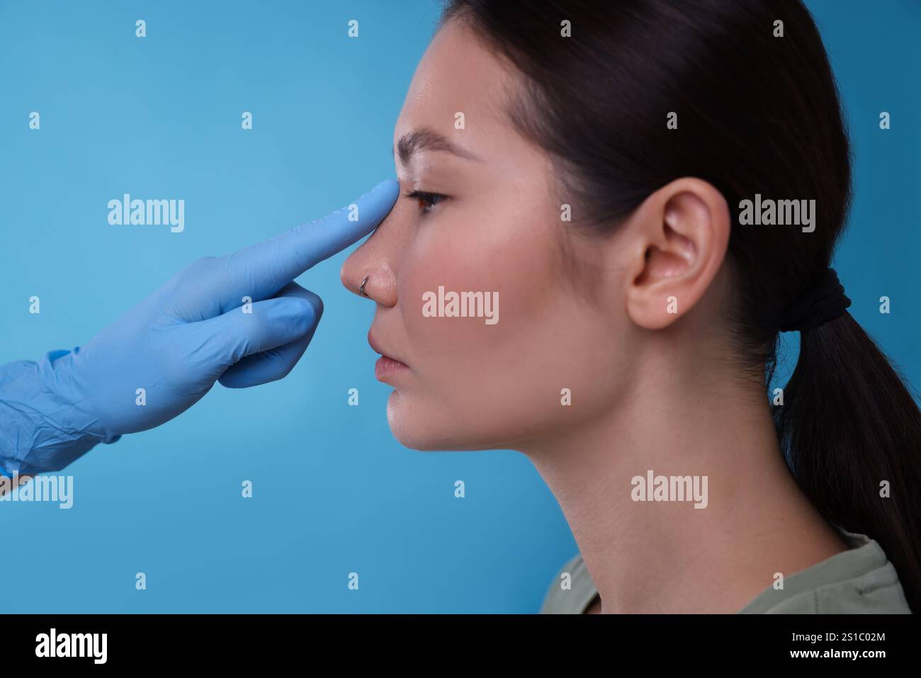 Doctor checking patient's nose before plastic surgery operation on ...