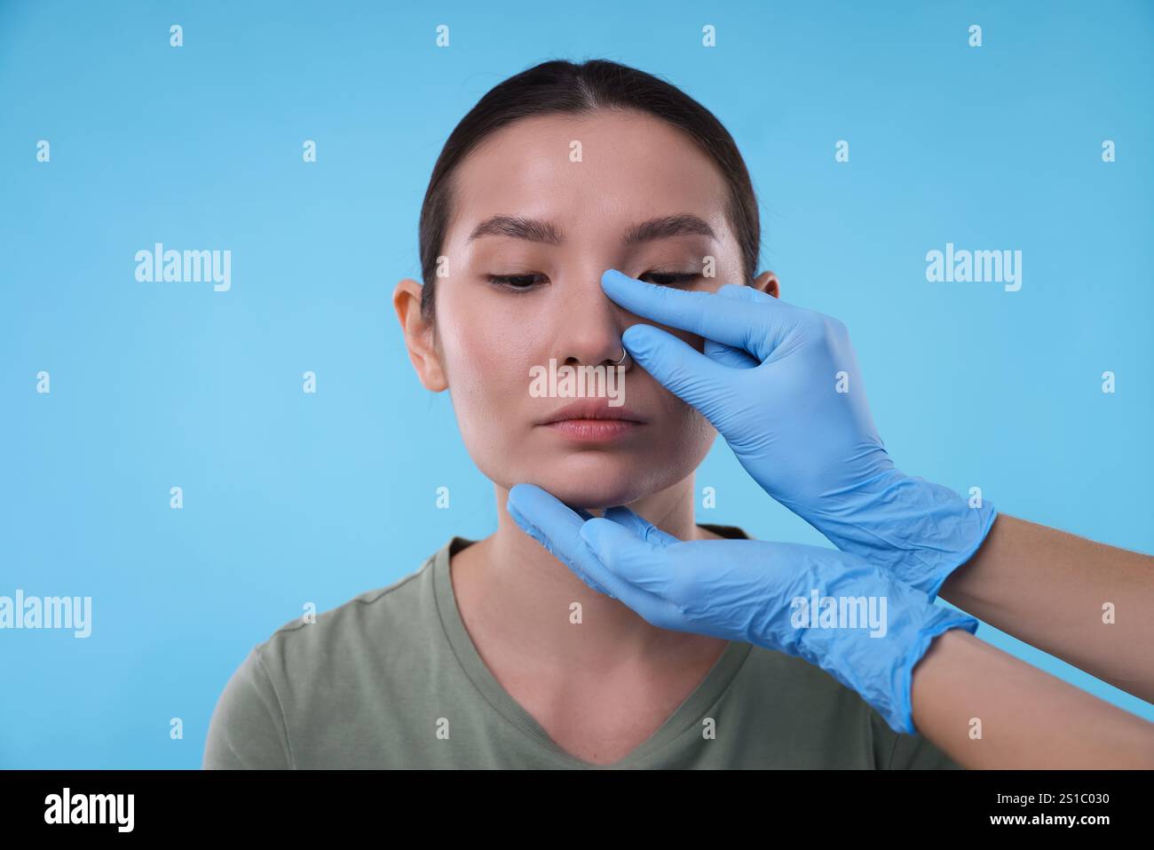 Doctor checking patient's nose before plastic surgery operation on ...