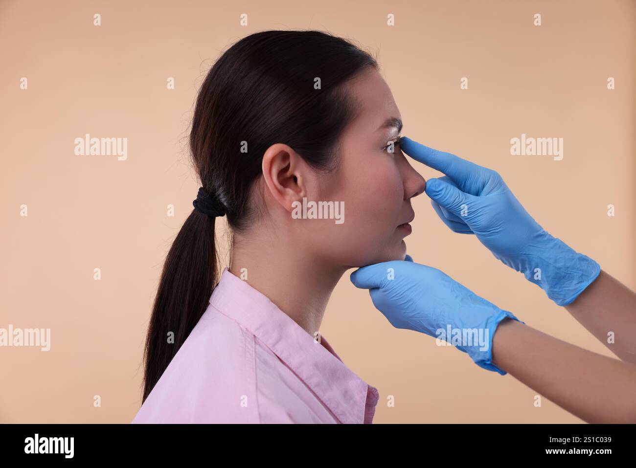 Doctor checking patient's nose before plastic surgery operation on ...