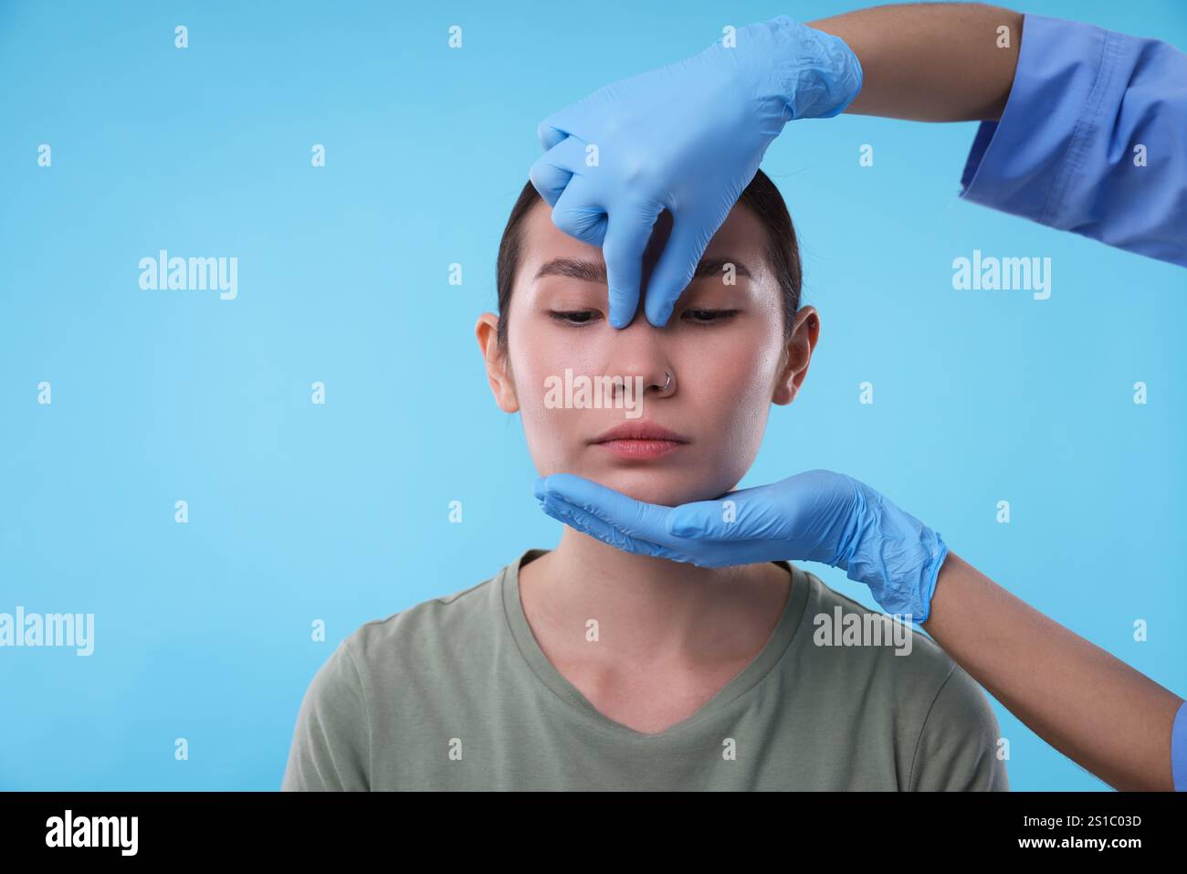 Doctor checking patient's nose before plastic surgery operation on ...