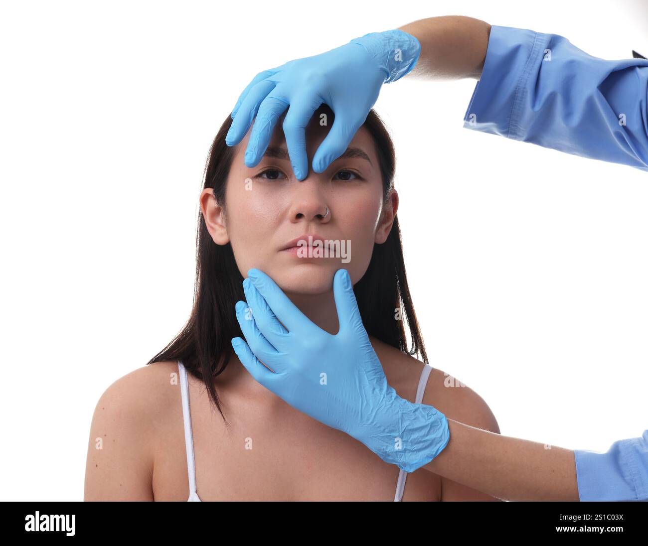 Doctor checking patient's nose before plastic surgery operation on ...
