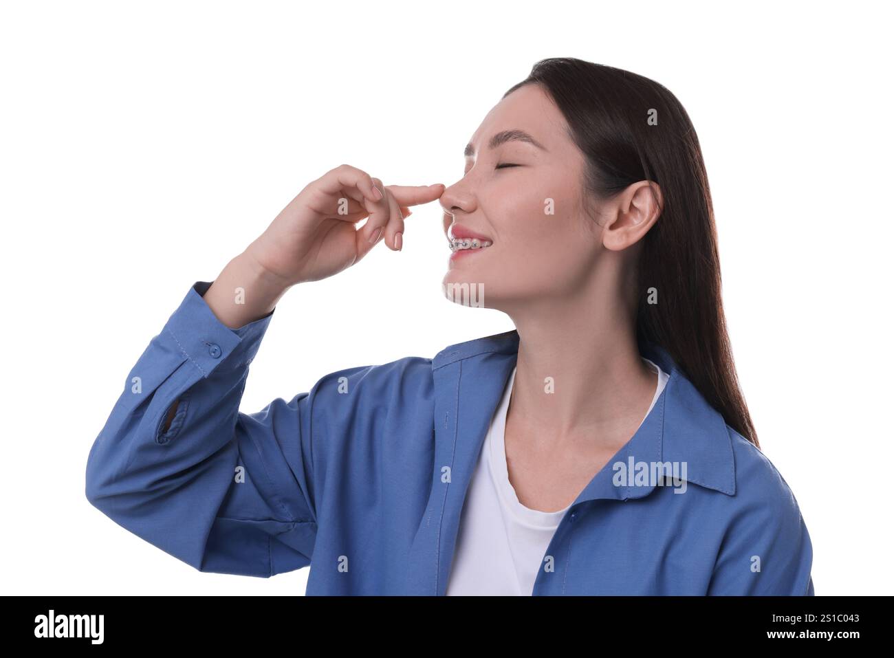 Young woman touching her nose on white background Stock Photo - Alamy