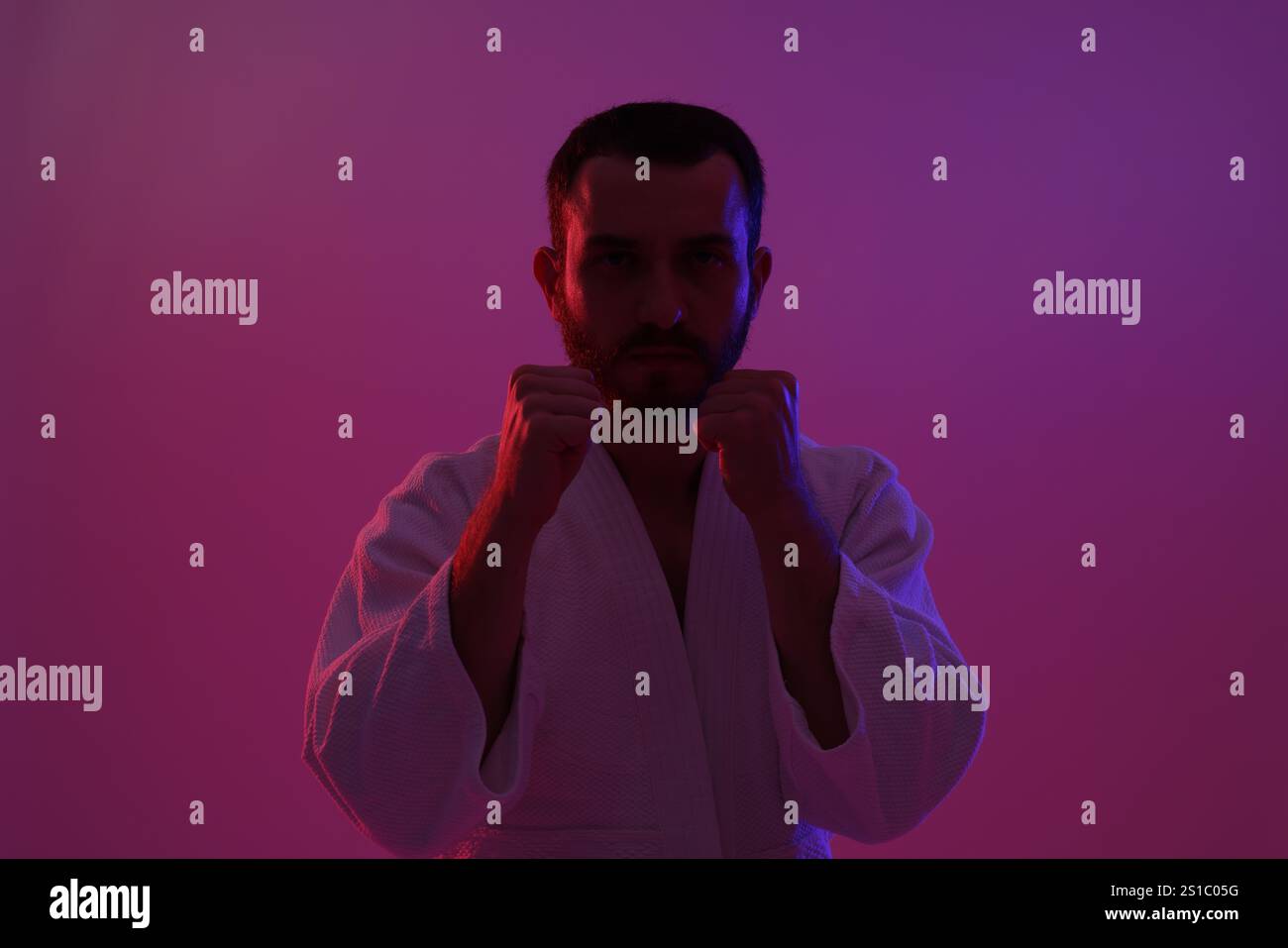 Karate fighter wearing uniform in color lights Stock Photo - Alamy